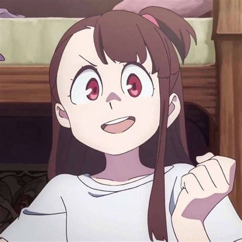 A Girl With Long Hair And Red Eyes Is Looking At Something In Her Hand While Standing Next To A Bed