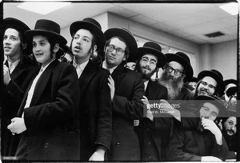 A Group Of Hasidic Men Crowd Together At A Unidentified Gathering In