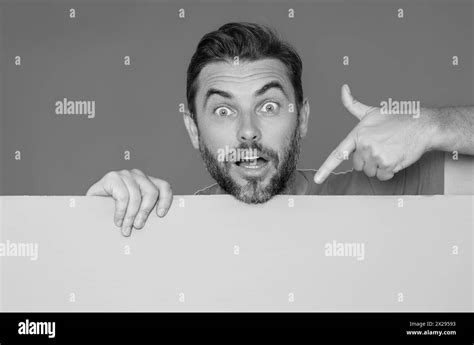 Handsome Man Holding Empty Board And Pointing Finger On Board Guy Showing Blank Board With