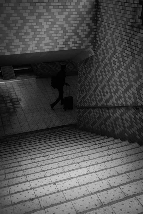 복도를 걸어가는 여행 가방을 든 사람 사진 Unsplash의 무료 검정 이미지