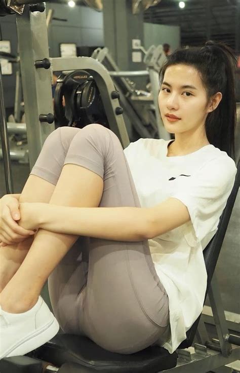 A Woman Sitting On Top Of A Gym Machine