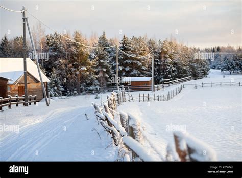 Winter With Lot Of Snow In Russian Village Rural Street In Sunset