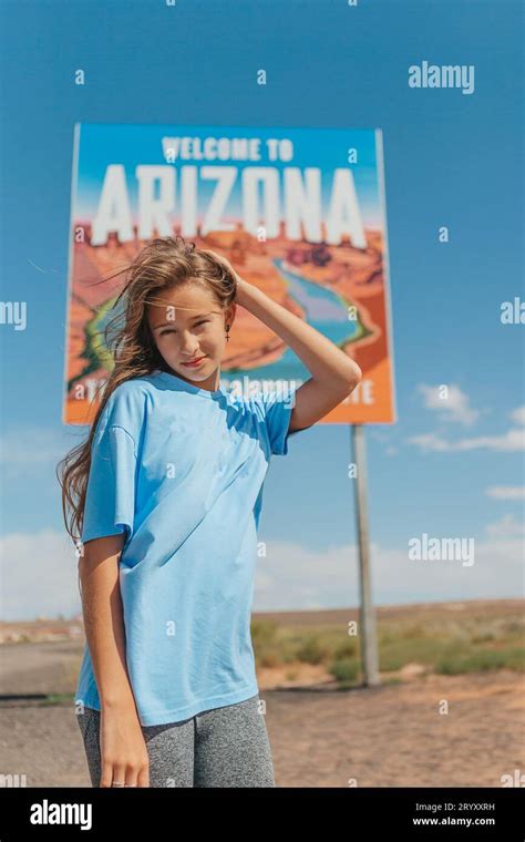 Beautiful Woman On Her Trip To The Usa On The Background Of Welcome To Arizona State Border Sign