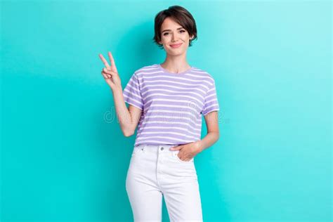 Photo Of Nice Cute Lady Arm Demonstrates V Sign Dressed Fashionable Striped Clothes Good Mood