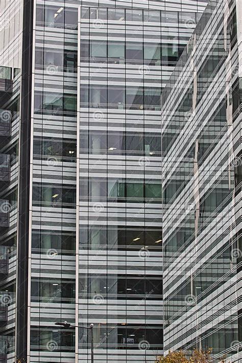 Modern Office Building With Glass Facade And Grid Pattern In