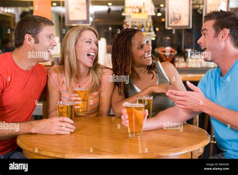 Two Couples Having Beer Together Stock Photo Alamy