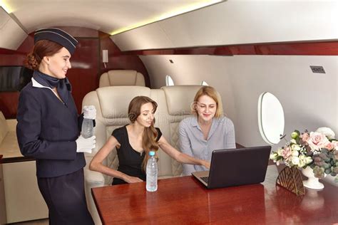 Air Hostess Inside Airplane Serves First Class Passengers Stock Image