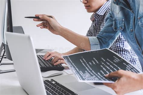Two Professional Programmers Cooperating At Developing Programming And Website Working In A