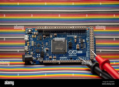 Arduino Due Displayed On Jumper Wire Background With Meter Probes Stock