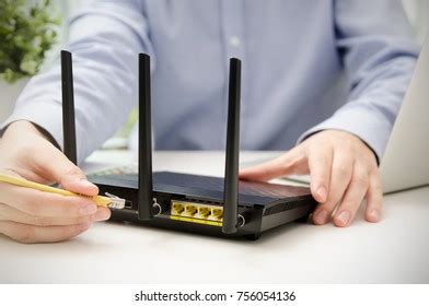 Man Plugs Ethernet Cable Into Router Stock Photo Shutterstock