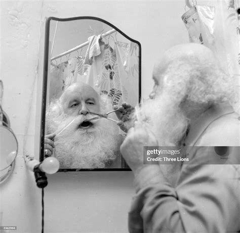 Santa Claus Keeps His Beard In Trim At The Start Of The Christmas