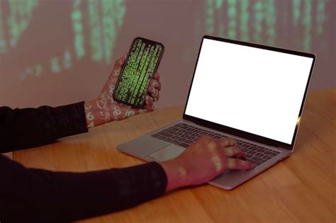 Premium Photo Cropped Shot Of Hacker Hands Holding A Mobile Phone And