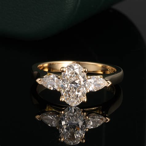 Oval And Pear Cut Diamonds Three Stone Engagement Ring