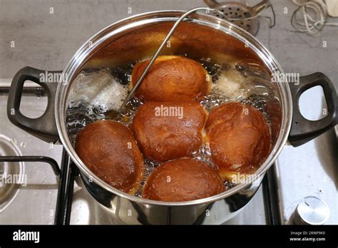 Making Homemade Yeast Raised Donuts Deep Frying In Lard Fat With A