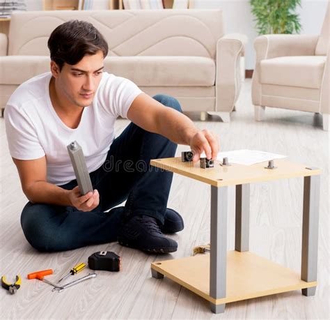 Man Assembling Shelf At Home Stock Photo Image Of Assembly Difficulty