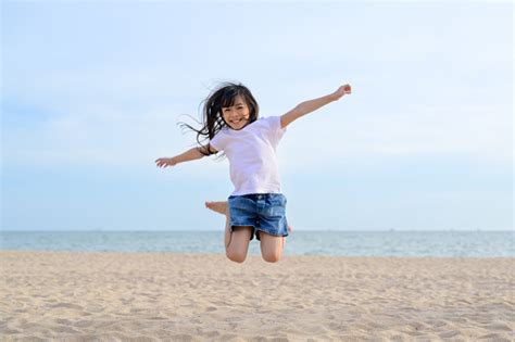 해변에서 점프하는 행복한 소녀 휴가 휴가에 해변 여행을 즐기는 쾌활한 딸 해변 여행 개념을 가진 아이들 달리기에 대한 스톡 사진 및 기타 이미지 Istock