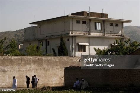 People Walk Past Osama Bin Ladens Compound Where He Was Killed News Photo Getty Images