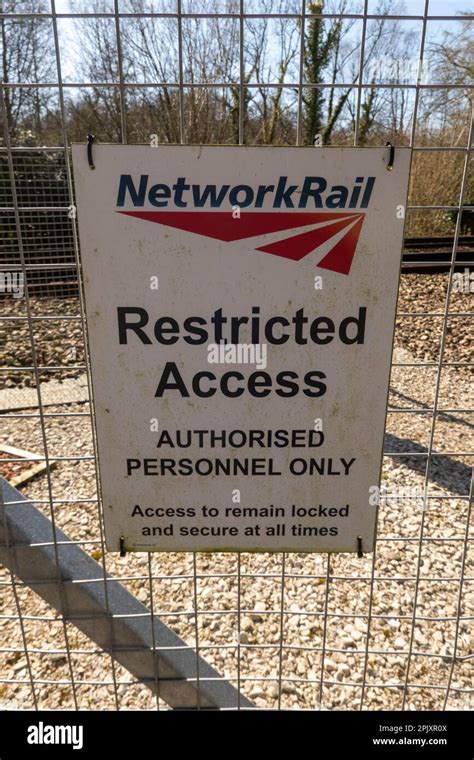 Network Rail Warning Signs Fixed To A Metal Fence Alongside A Railway