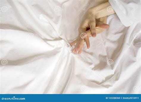 Couple Having Sex Hand Clutches Grasps A White Crumpled Bed Sheet In A Hotel Room A Sign Of