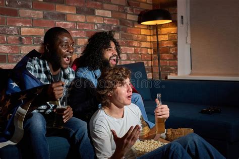 Relaxed Guys Watching Football Sport Match At Home Multiethnic Group