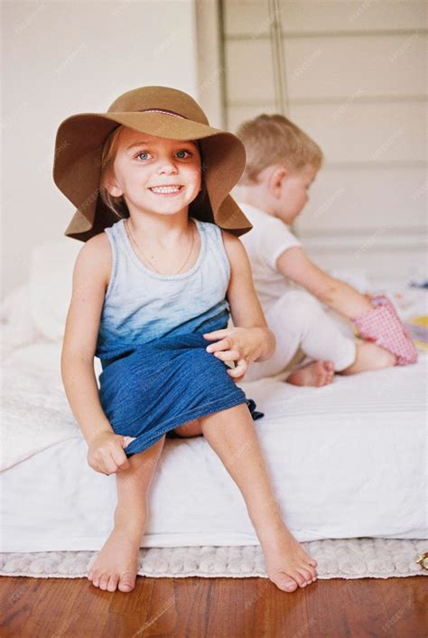 Premium Photo Young Girl Wearing A Dress And Large Floppy Hat On A