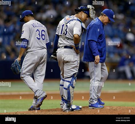 Kansas City Royals Manager Ned Yost Right And Catcher Salvador Perez Center Look Down As