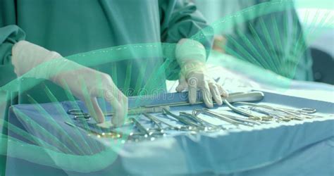 Animation Of Dna Strand Over Biracial Male Surgeon In Hospital Stock