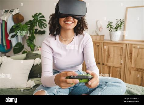 Happy Girl Wearing Virtual Reality Simulators Holding Game Controller