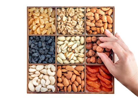 Hand With Assorted Nuts And Dried Fruit Collection Different