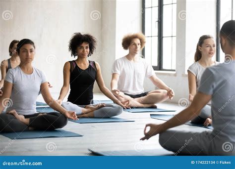 Group Of Diverse People Sitting Cross Legged Do Meditation Practice