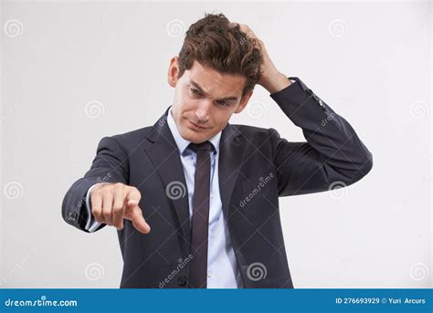 Getting In Touch With Technology A Young Businessman Looking Confused