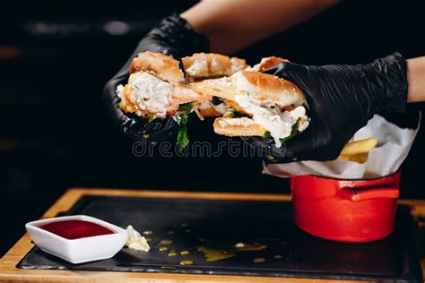 Juicy Burger With Poached Egg Salmon Steak And Cheddar Cheese The Chef Tears The Burger In His