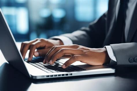 Premium Photo A Man Is Typing On His Laptop With His Hands On The Keyboard