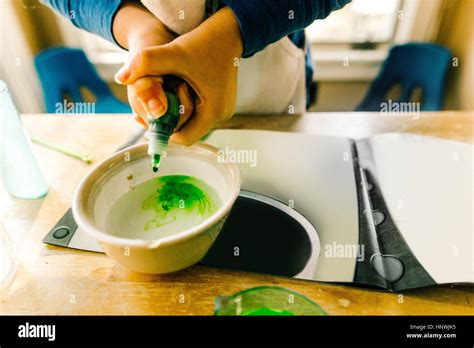 Hands Of Girl Doing Science Experiment With Green Liquid Stock Photo Alamy