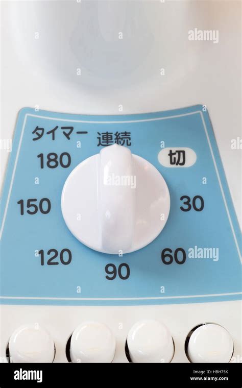 Analog Timer Device Of A Bule And White Japanese Electric Fan Stock