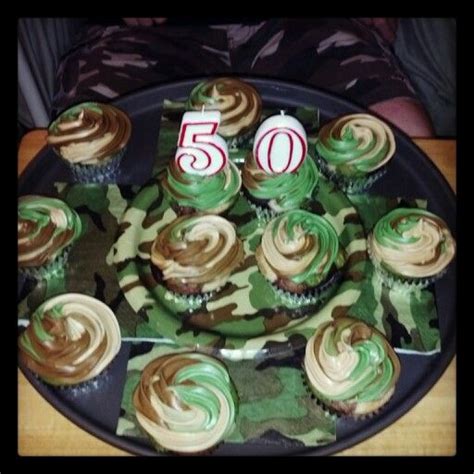 Cupcakes With Green And Brown Frosting Are Arranged On A Black Platter