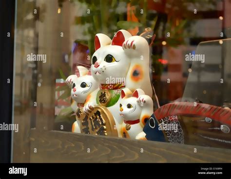 Maneki Neko Japanese Lucky Cat Figurine In A Store Window Featuring A