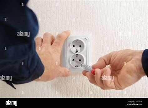 Electrician Installing Wall Socket In New Building Closeup Stock Photo Alamy