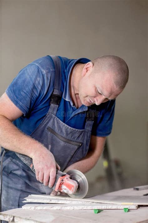 Professional Tiler Cutting Ceramic Tile For The Floor Or Wall Flooring And Tiling Stock Image