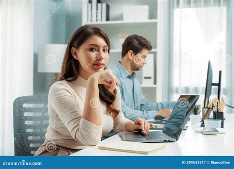 Woman Working On Laptop Taking Note To Pose For Looking At Camera Postulate Stock Image