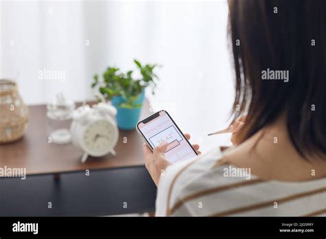 Japanese Woman Checking Body Temperature Stock Photo Alamy