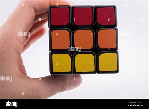 Hand Holding Rubik S Cube On White Background Stock Photo Alamy