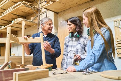 Mentor Guiding Apprentices In Woodworking At A Busy Lumberyard Stock Image Image Of Learning