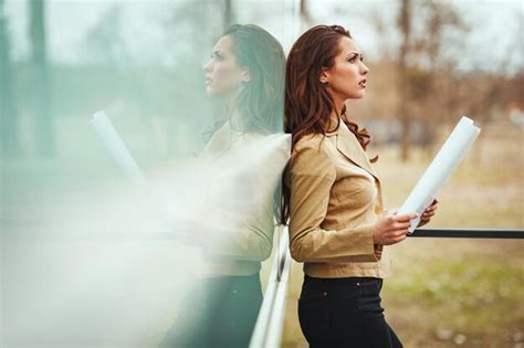 Premium Photo Young Successful Female Engineer With Blueprints In Her