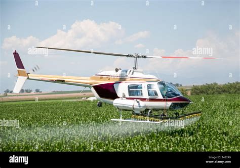 Helicopter As A Crop Duster In North Central Colorado Spraying A Corn