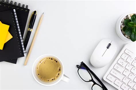 Top View Of Modern White Office Desk With Computer Keyboard Blank Notebook Page And Other