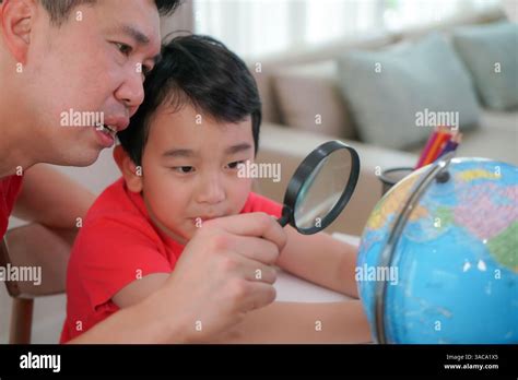 Father And Son Explore The Globe At Home Nurturing Curiosity Bonding