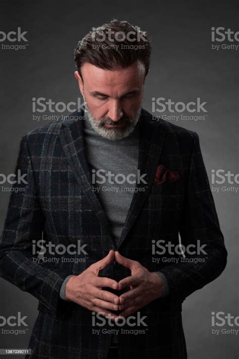어두운 배경에 고립 된 사진 스튜디오에서 수염과 캐주얼 비즈니스 옷을 입은 세련된 우아한 선임 사업가의 초상화 개념에 대한 스톡