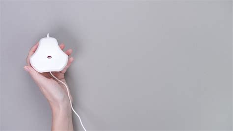 Premium Ai Image Hands Holding White Monitor Calibrator On The Grey