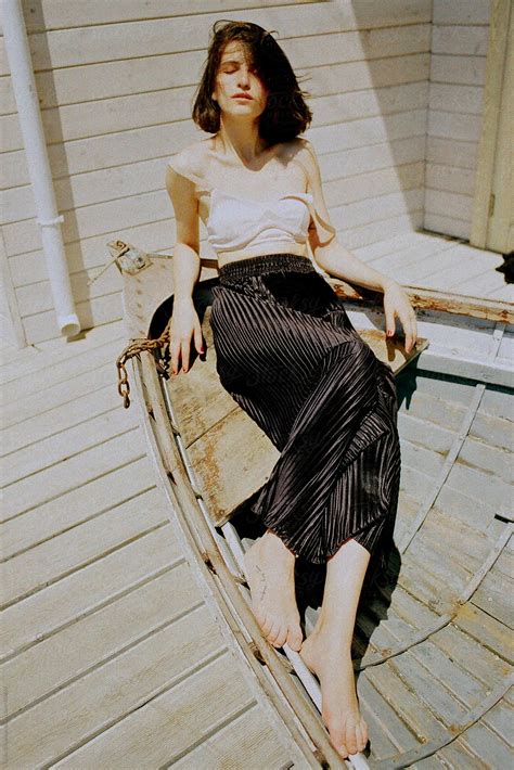 Girl Sitting On The Boat By Stocksy Contributor Amor Burakova Stocksy